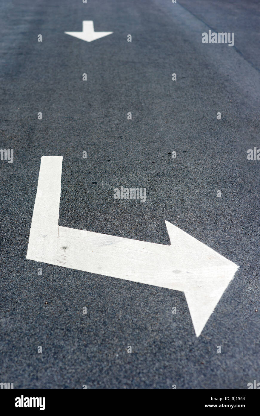 Arrows with direction signs on a asphalted street - image Stock Photo ...