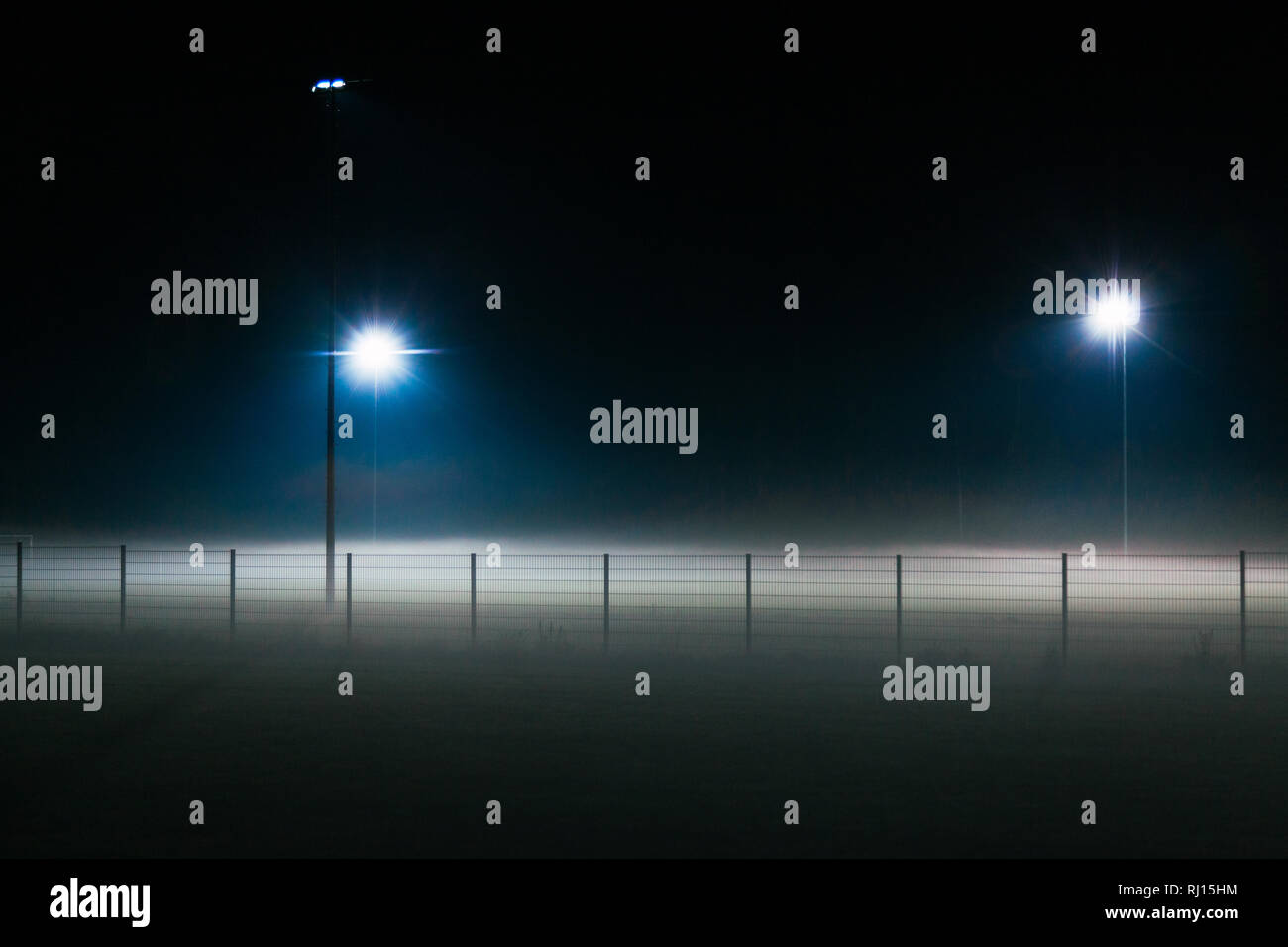 Lonely football field covered by fog at night only illuminated by ...
