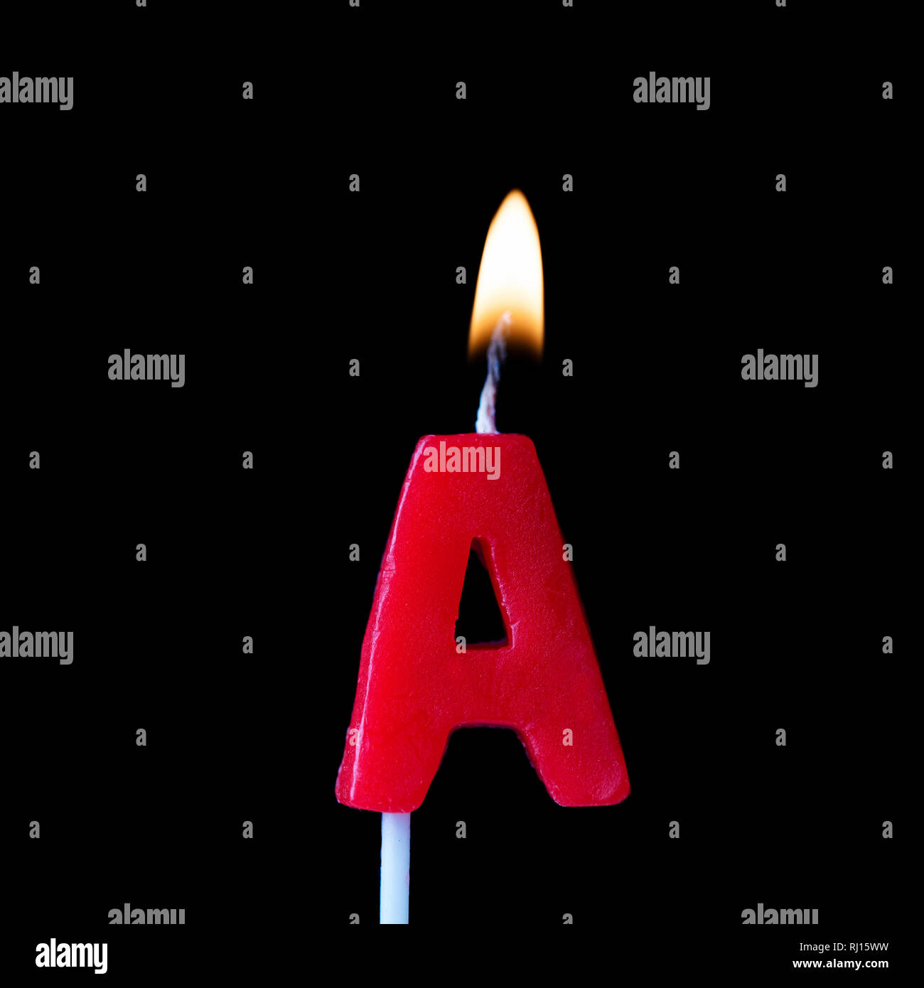 Letter A celebration birthday candle against a black background Stock ...