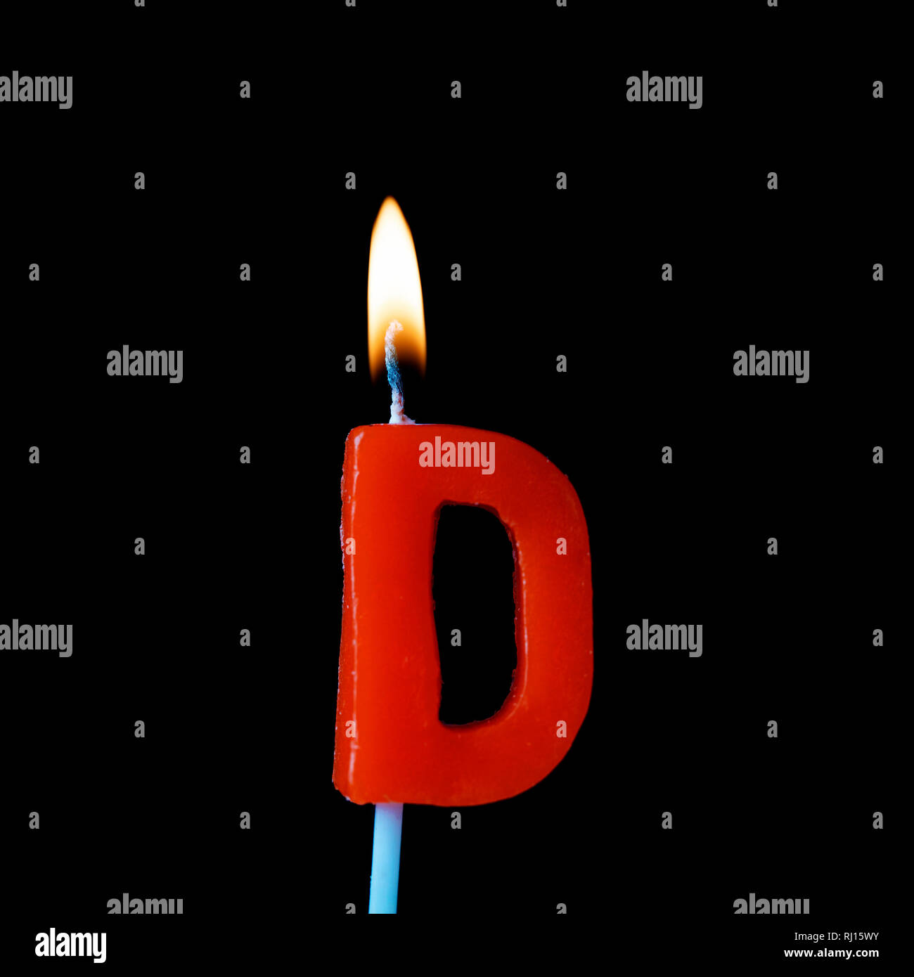 Letter D celebration birthday candle against a black background Stock ...