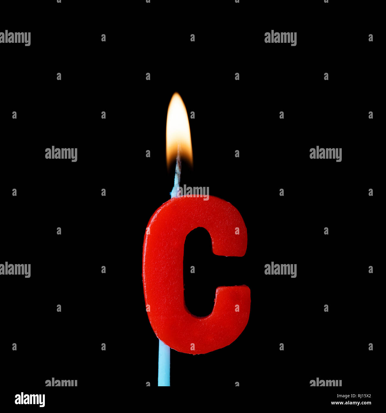 Letter C celebration birthday candle against a black background Stock ...