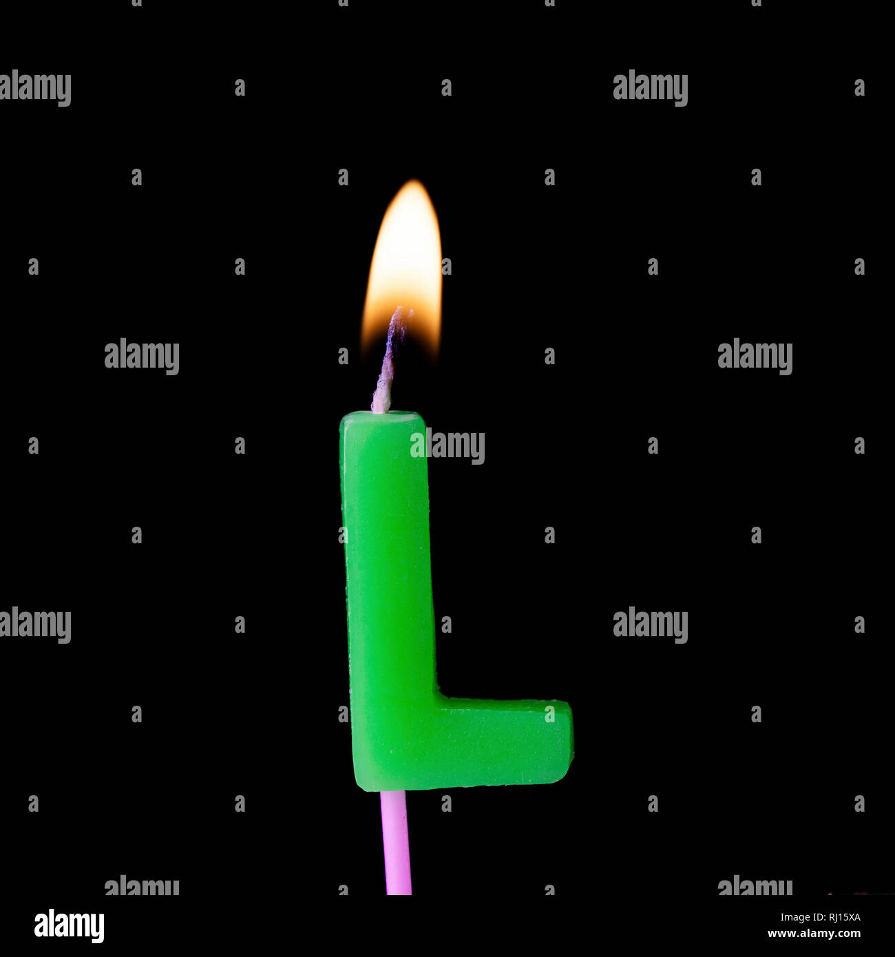 Letter L celebration birthday candle against a black background Stock ...