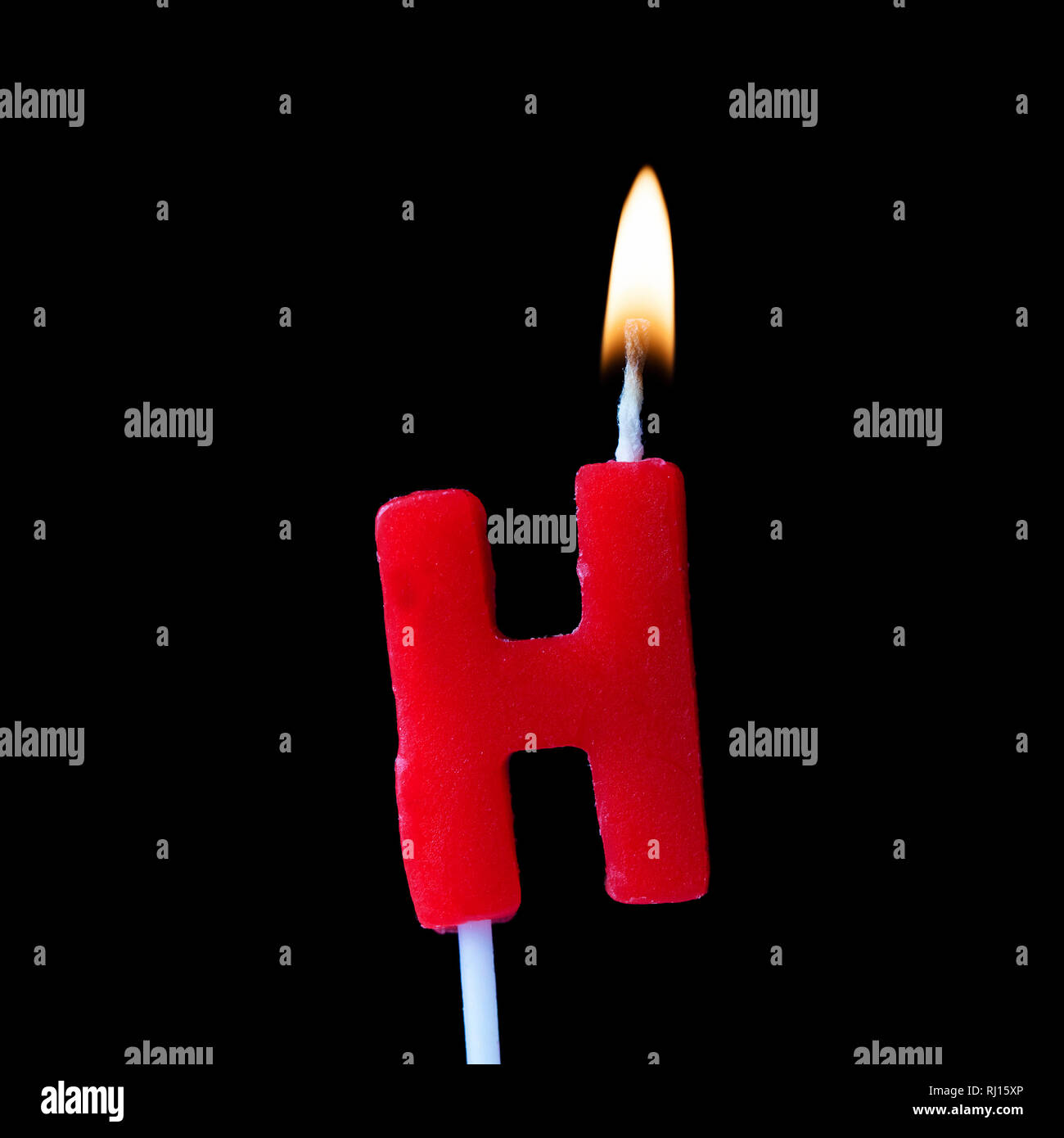 Letter H celebration birthday candle against a black background Stock ...