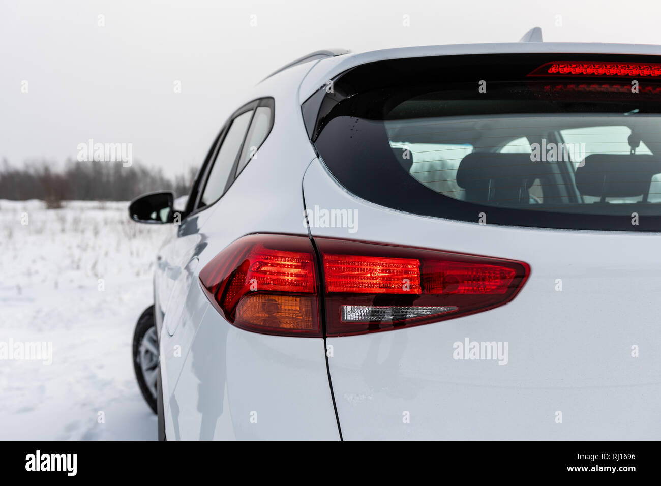 White modern car with lit brake lights. Rear view Stock Photo - Alamy