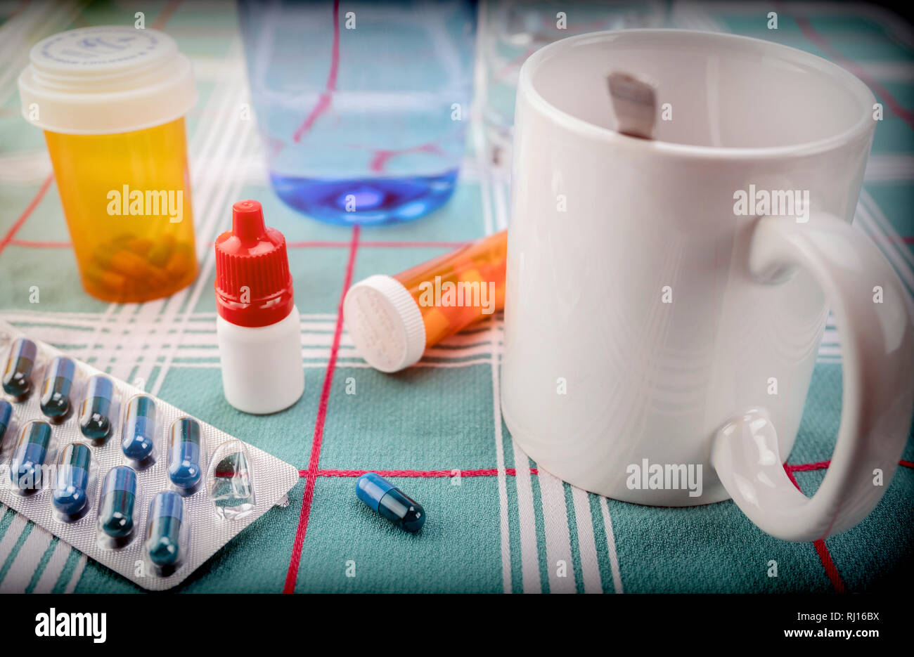 Medication during breakfast, capsules next to a glass of water ...