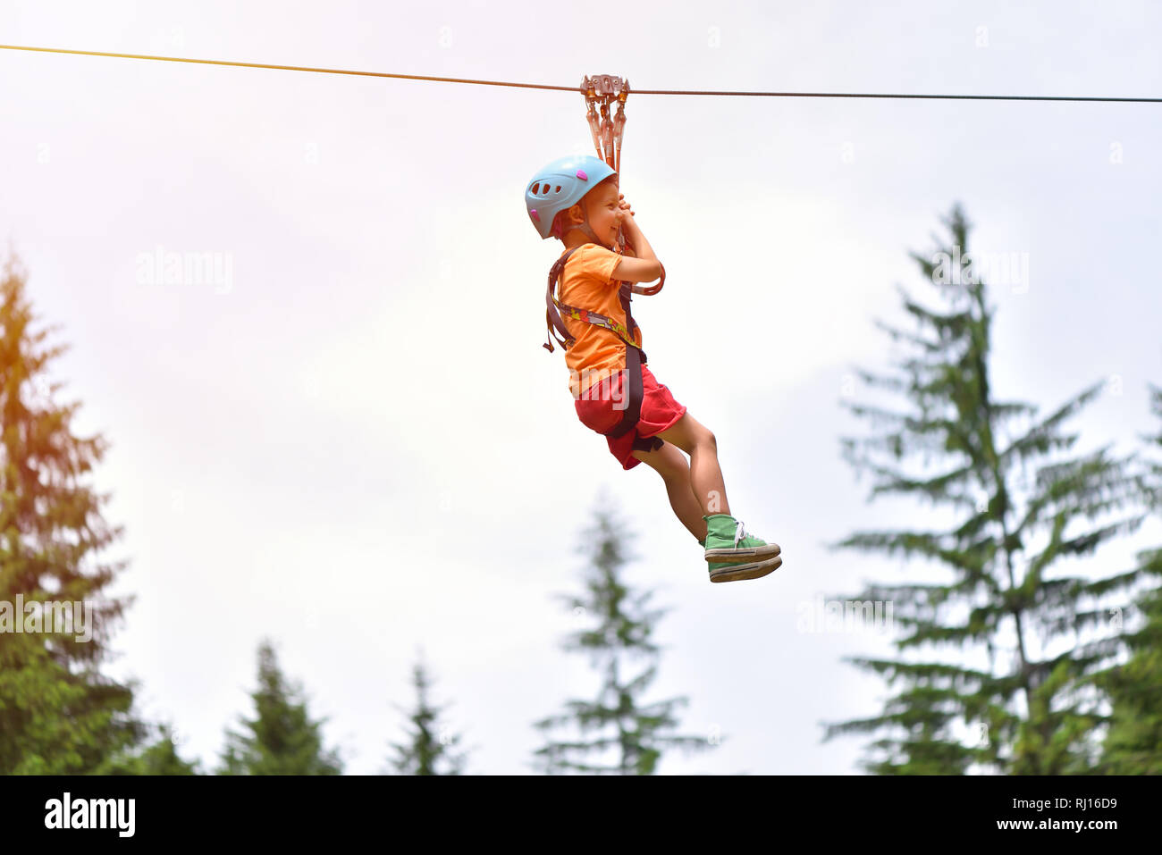 Boy on zip line hi-res stock photography and images - Alamy