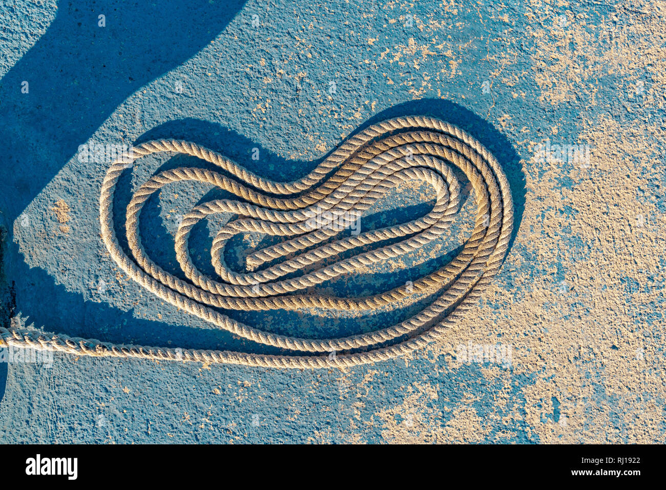 Nautical rope. Bollard rope on pier ground Stock Photo - Alamy