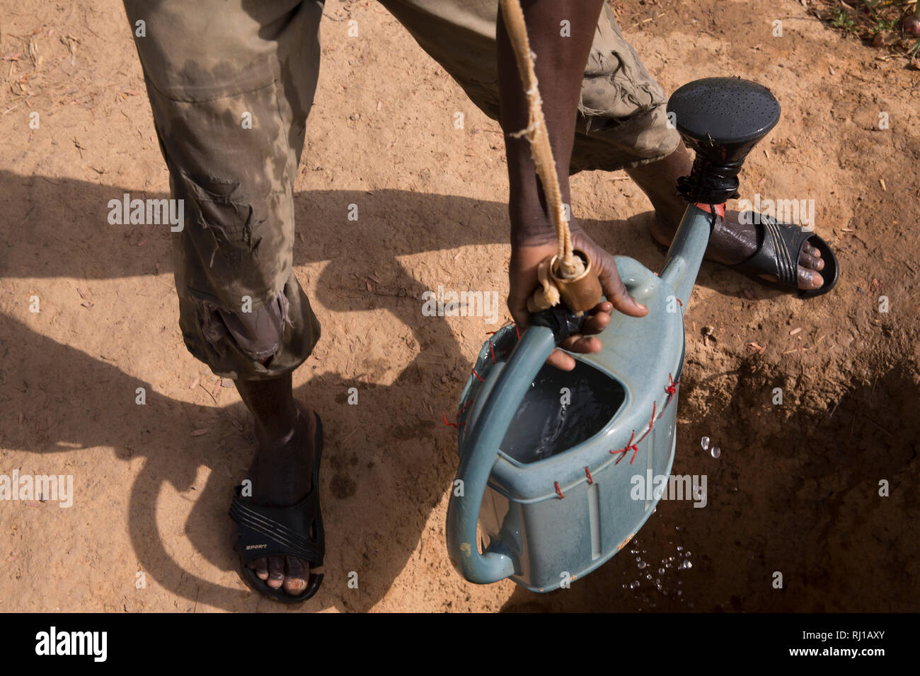 Samba village, Yako Province, Burkina Faso: Denis Zoundi, drawing water ...