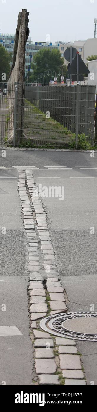 tiles on the ground that indicate where the Berlin Wall stood in ...