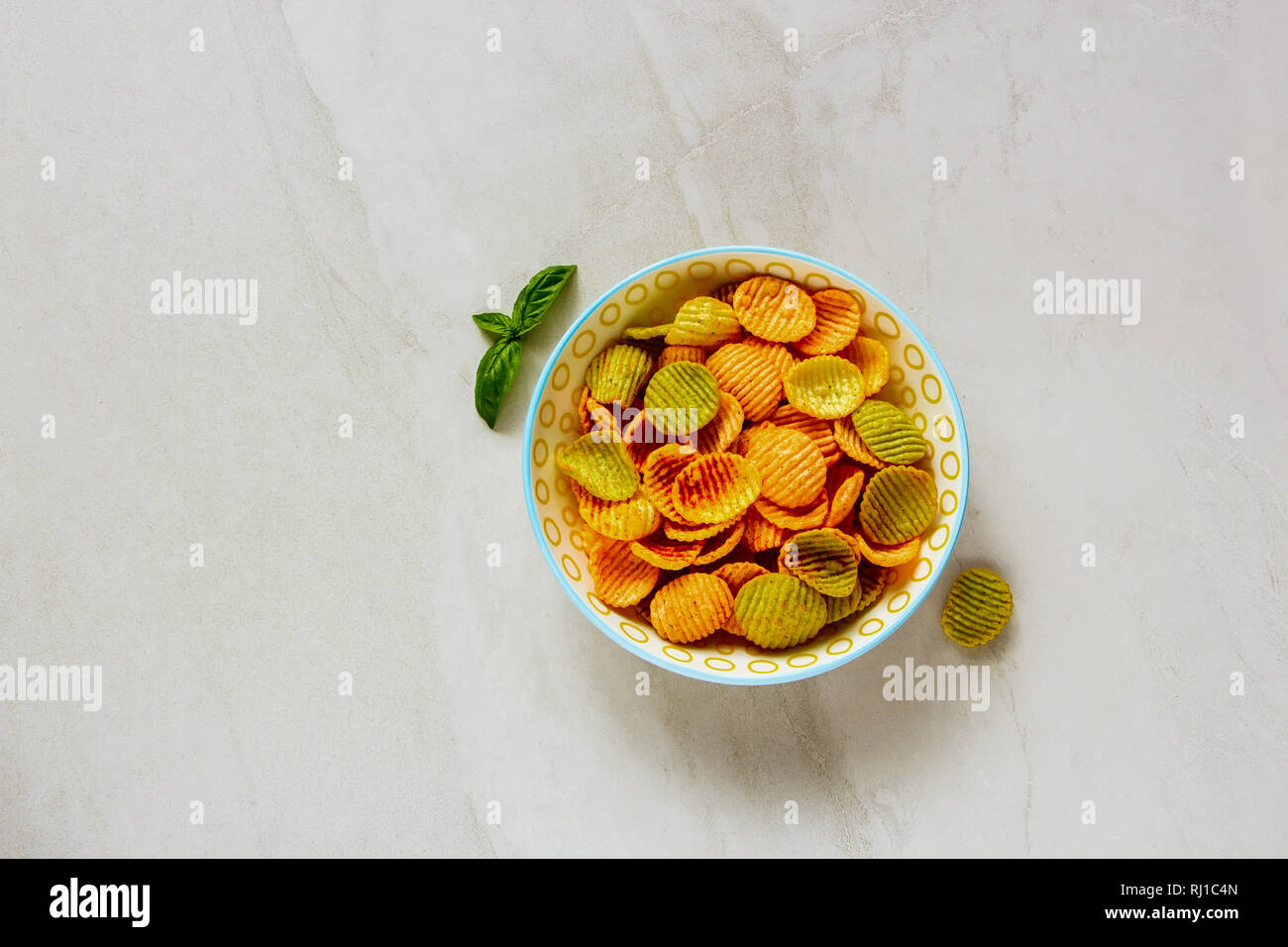Flat-lay of veggie chips on light background Stock Photo - Alamy