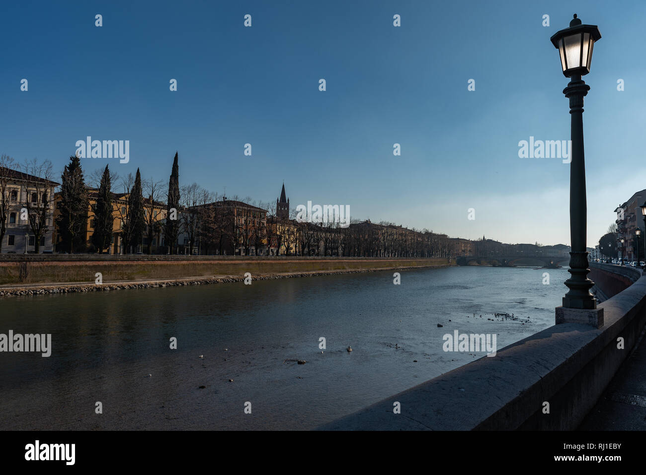 side view of the Adige river in Verona, on the right side an ...