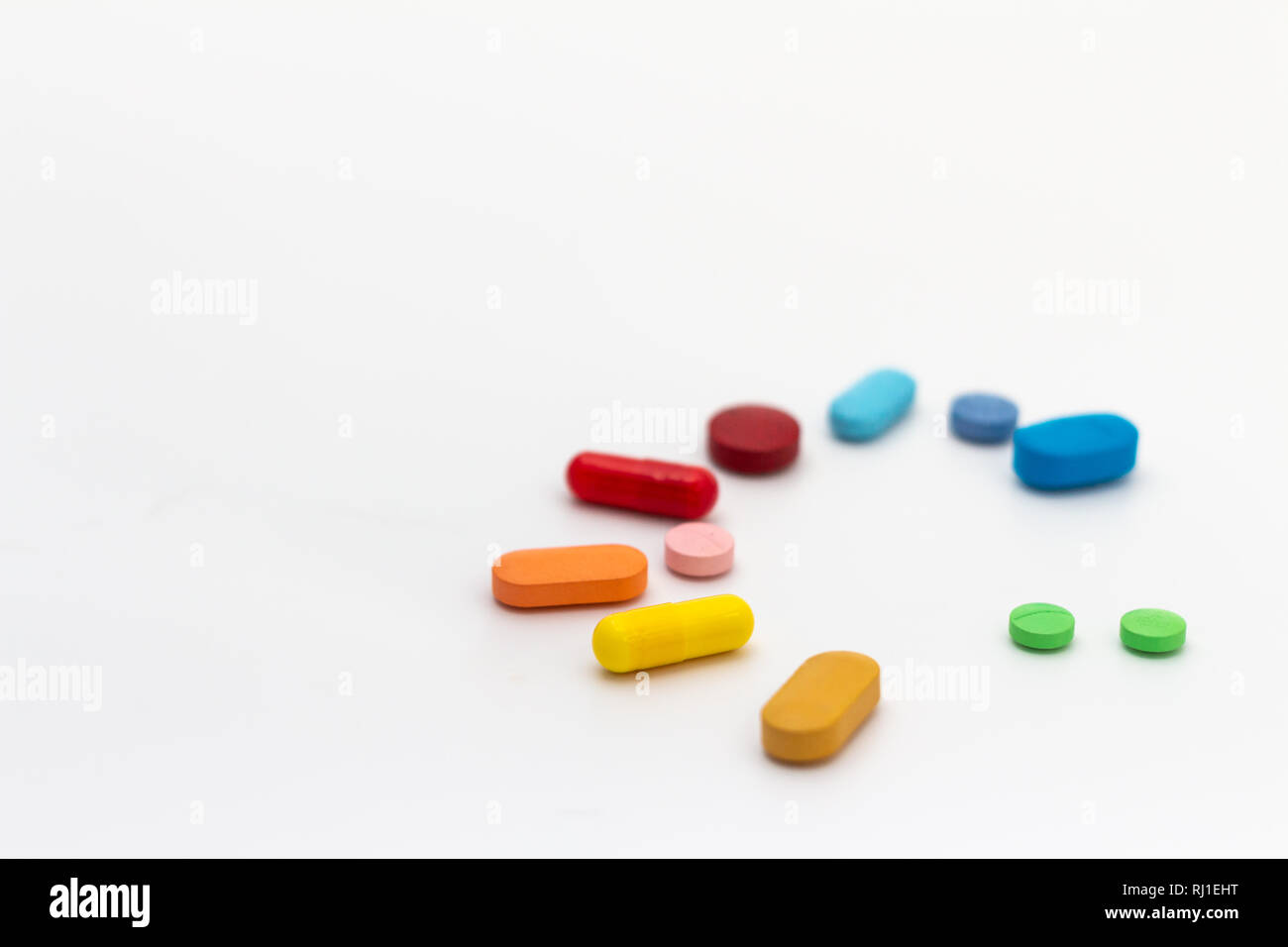 Pills of colors on a neutral white background. Medications forming a ...