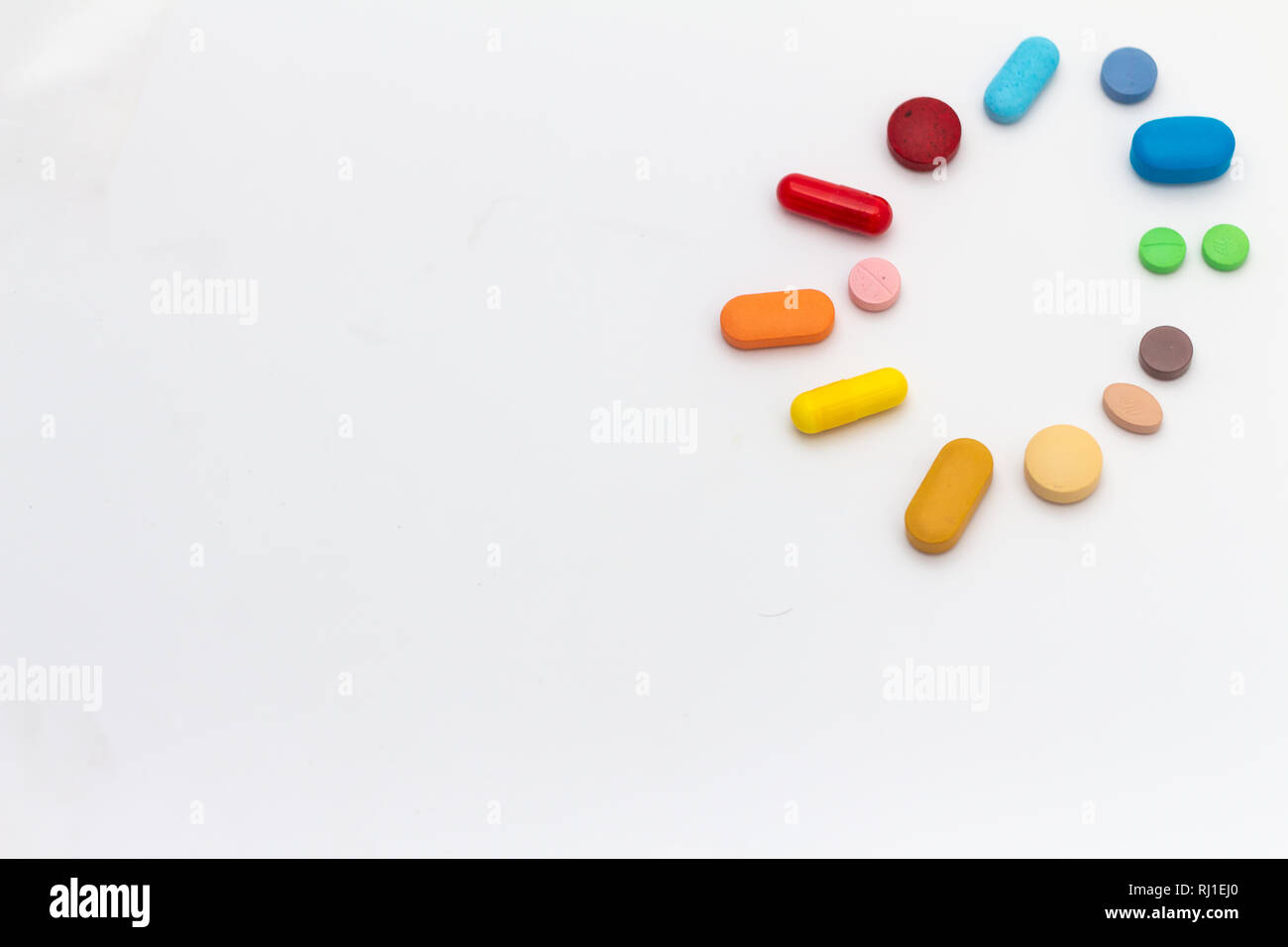 Pills of colors on a neutral white background. Medications forming a ...