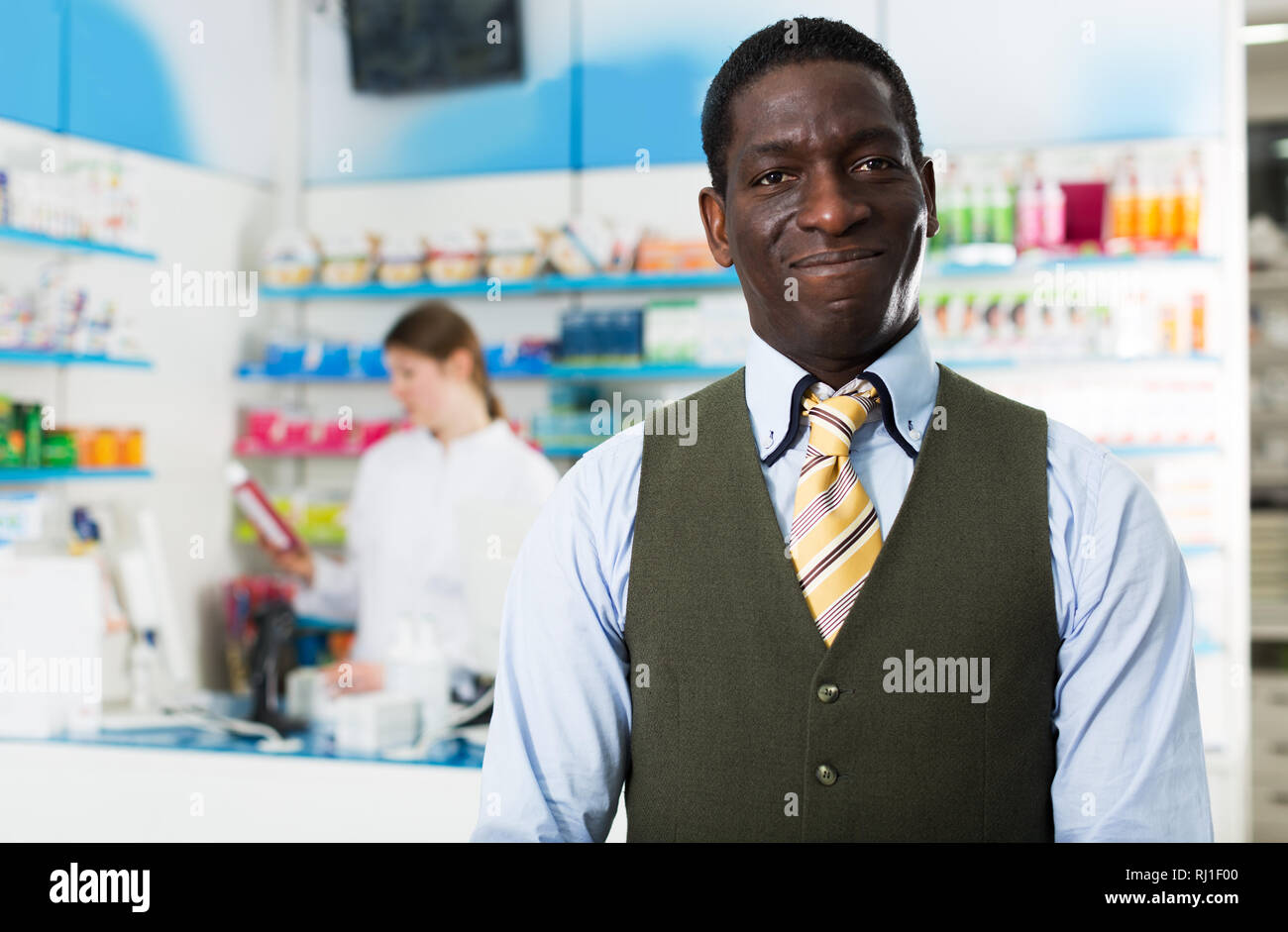 Portrait of smiling African American male customer standing in modern ...