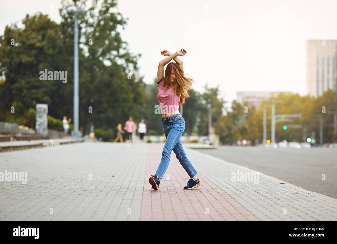Happy woman walking during on the streets Stock Photo - Alamy