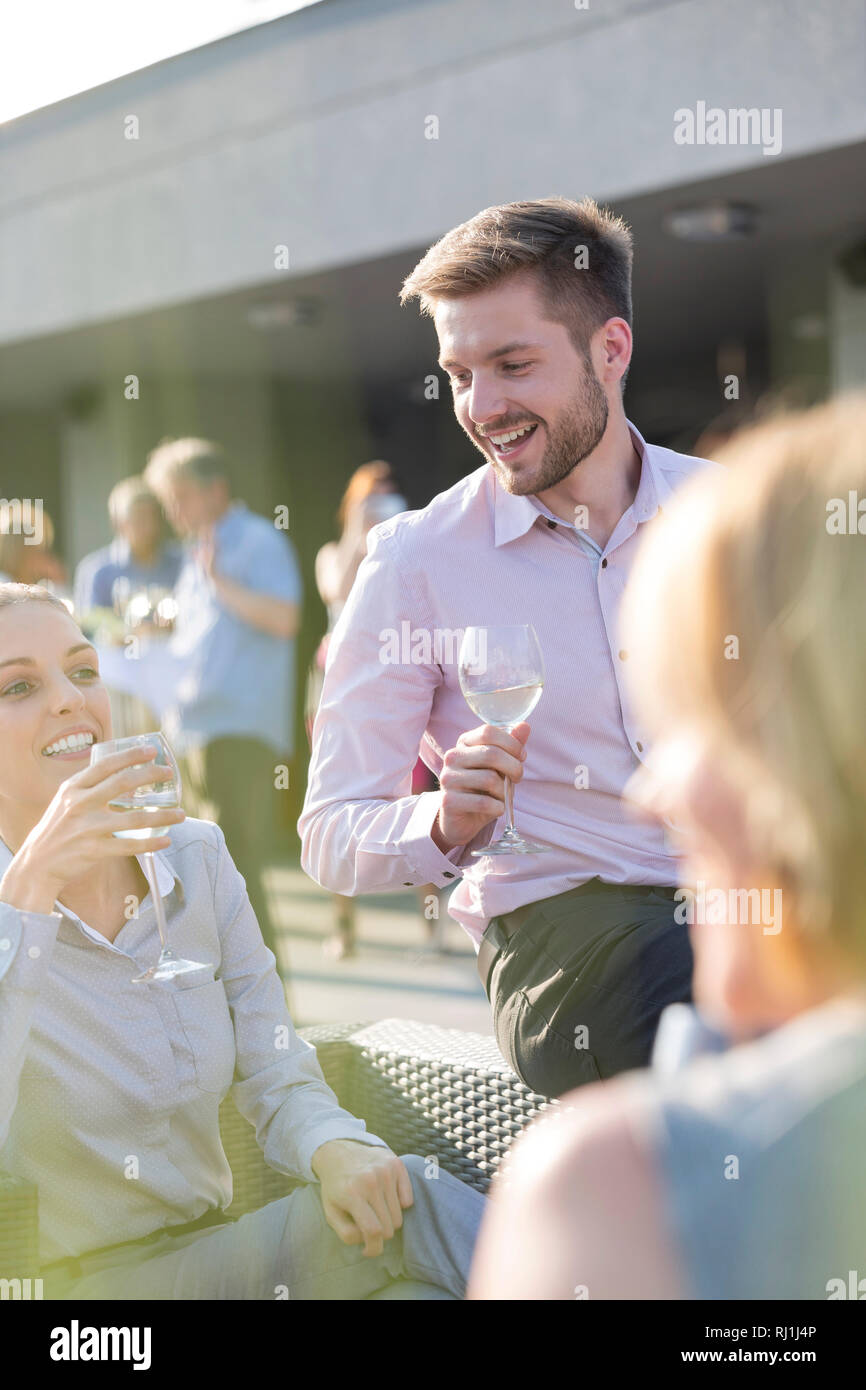 Happy business colleagues talking during success party on rooftop Stock ...