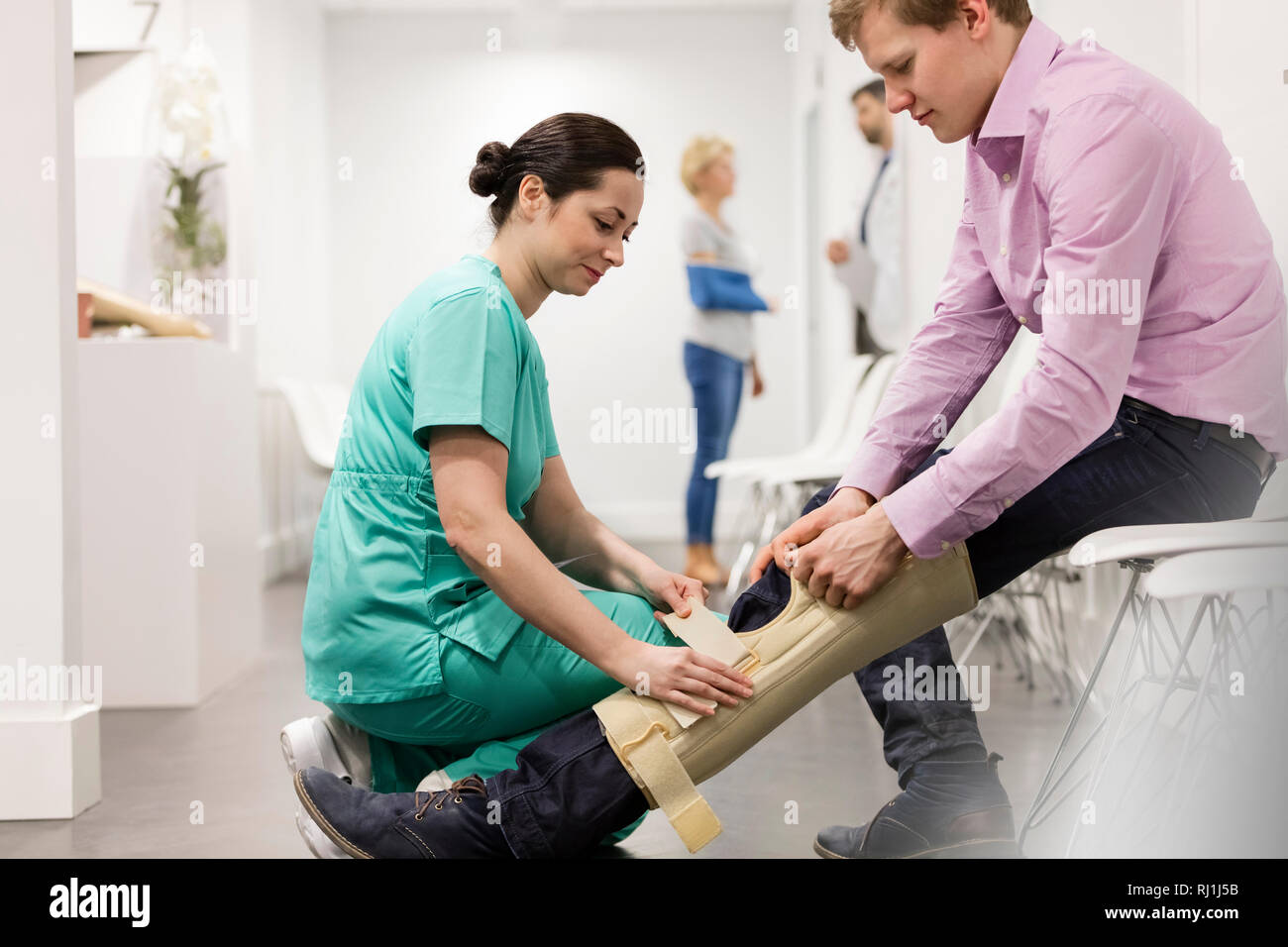 Assisting patient doctor in hospital hi-res stock photography and ...