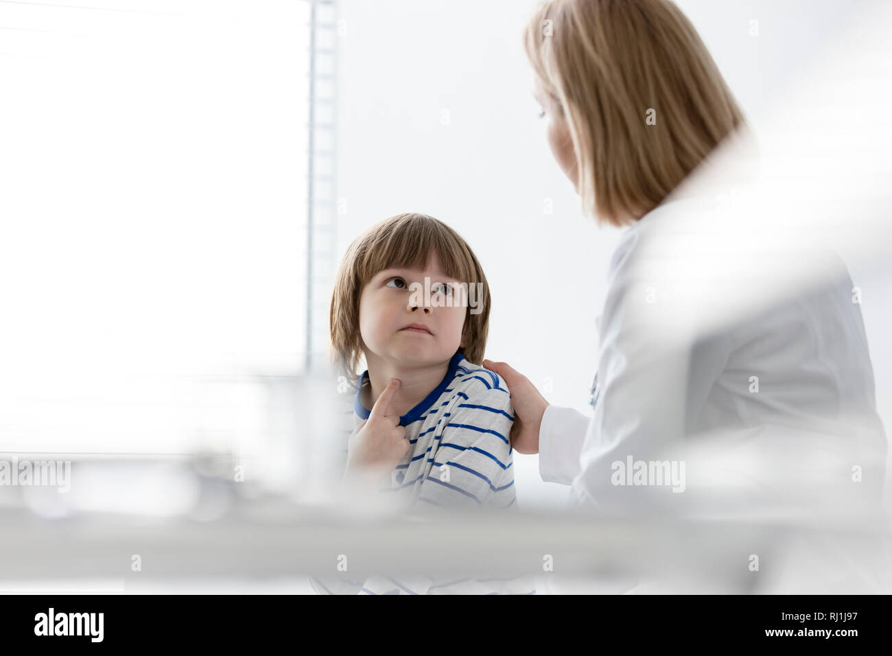 Ill boy talking to doctor at hospital Stock Photo - Alamy