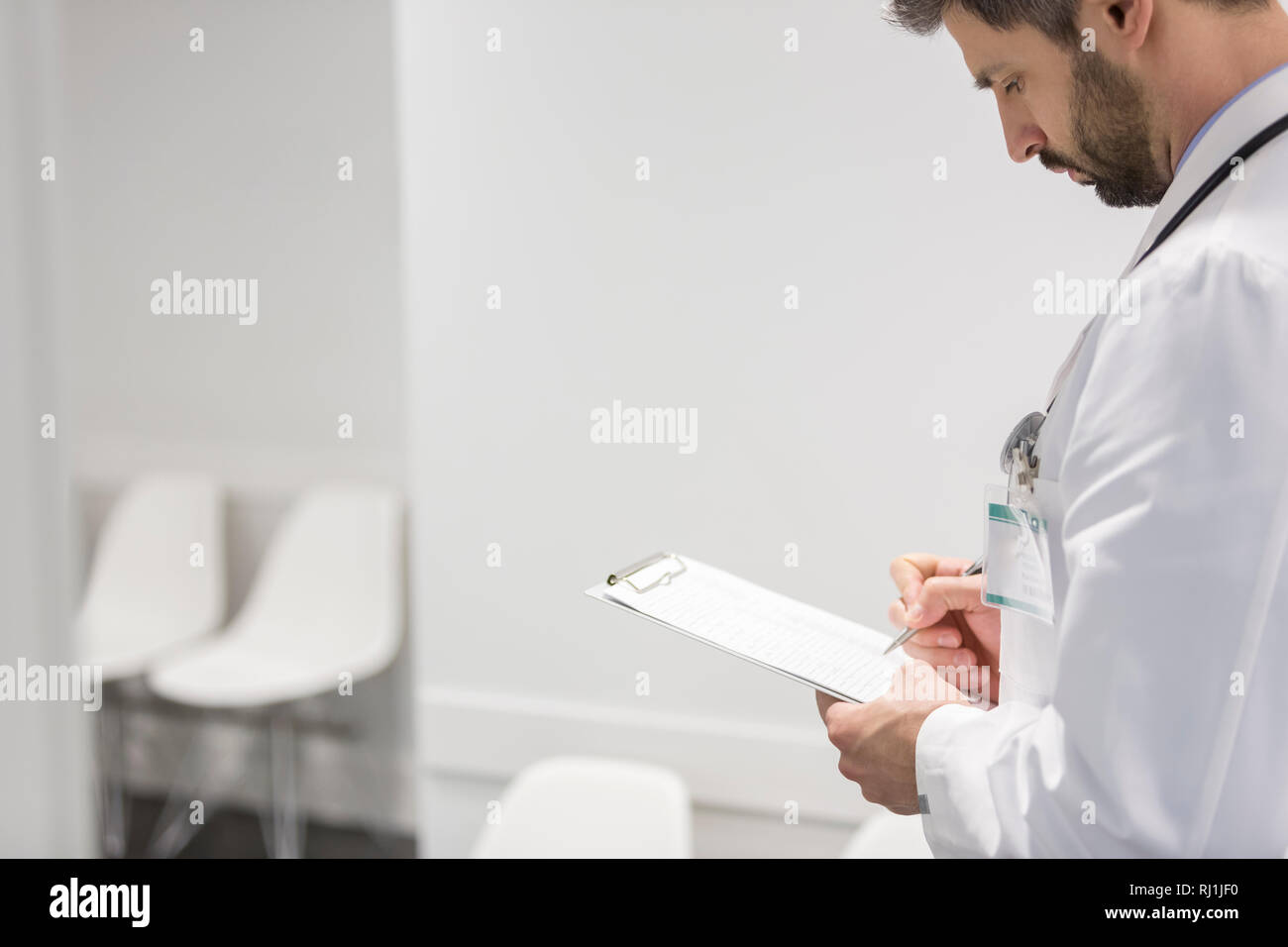 Doctor reviewing medical report at hospital Stock Photo - Alamy
