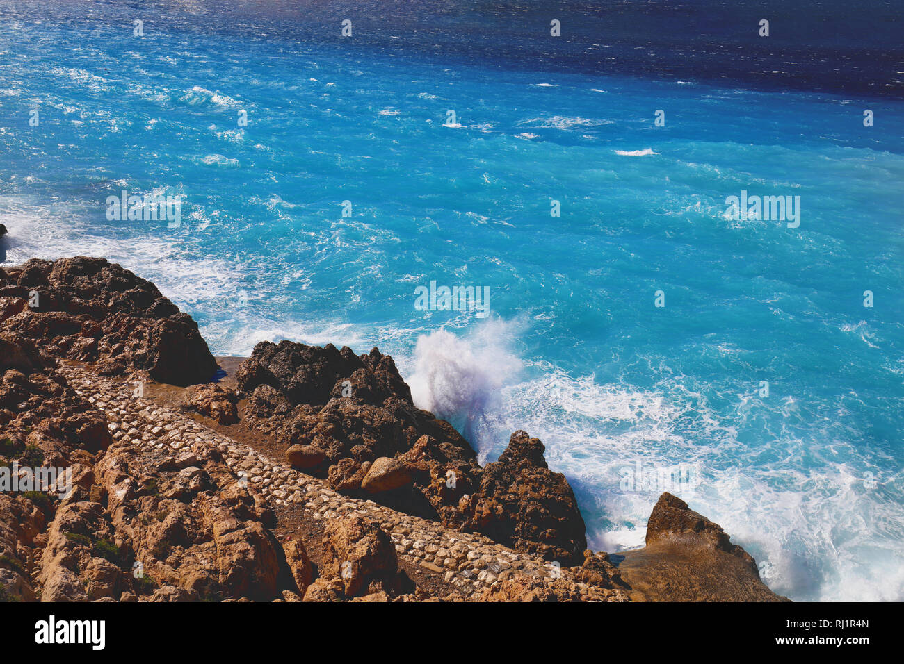Rocky seashore with beautiful blue sea water Stock Photo - Alamy