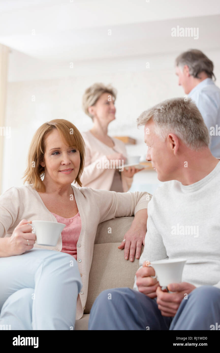 Mature couple talking in living room hi-res stock photography and ...