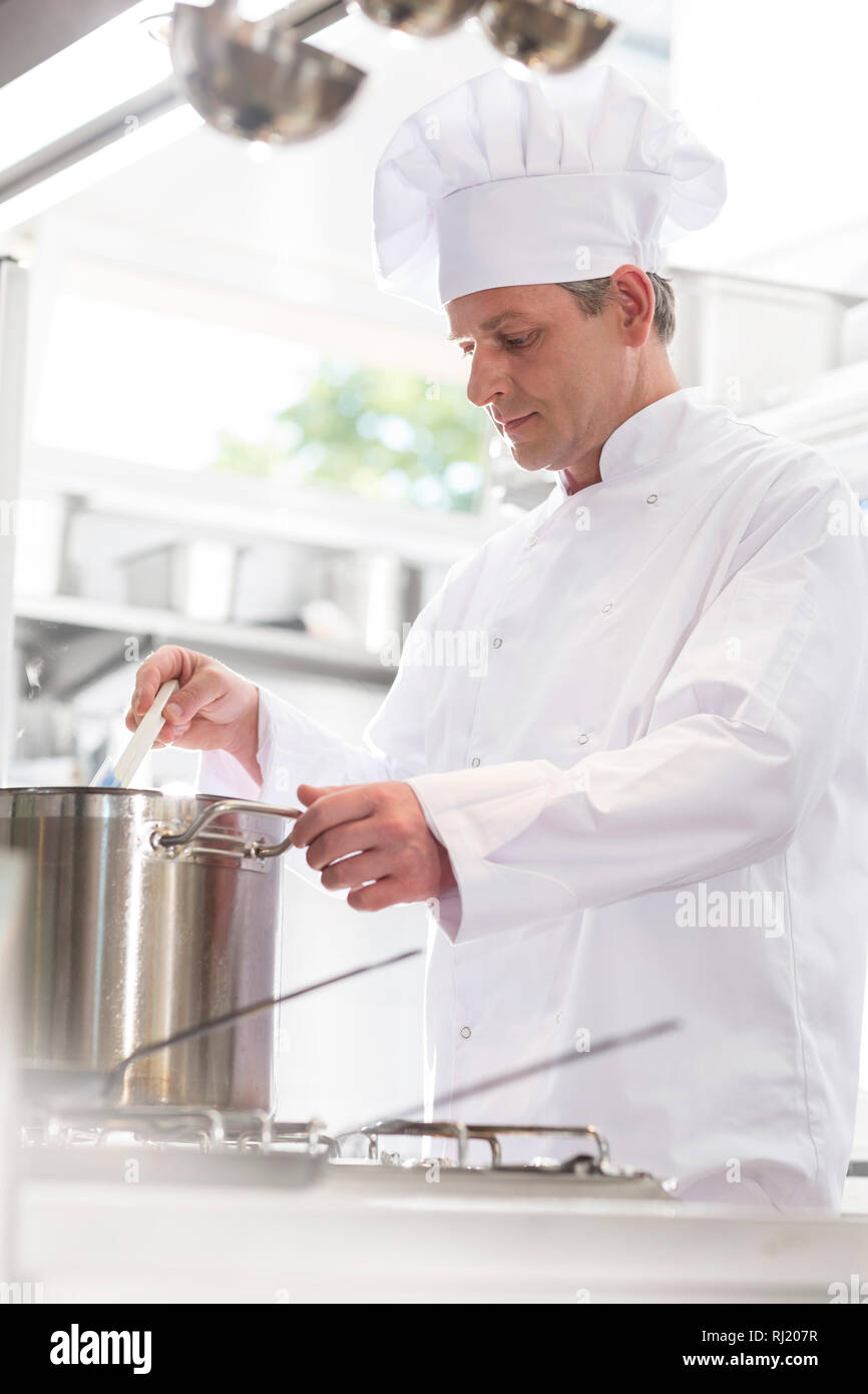 Chef cooking on stove hi-res stock photography and images - Alamy