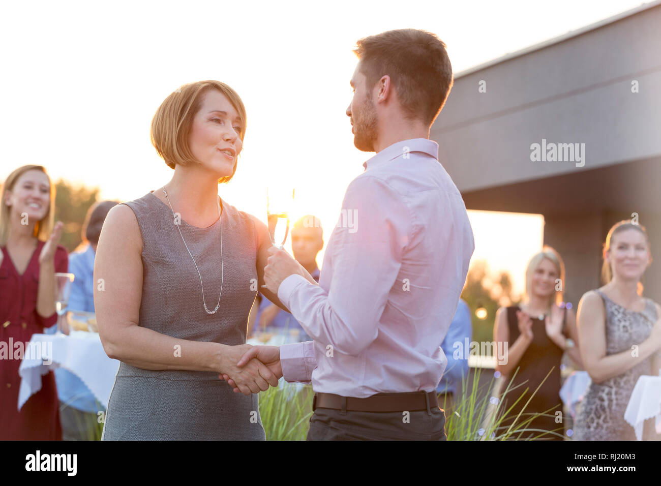 Rooftop party handshake hi-res stock photography and images - Alamy