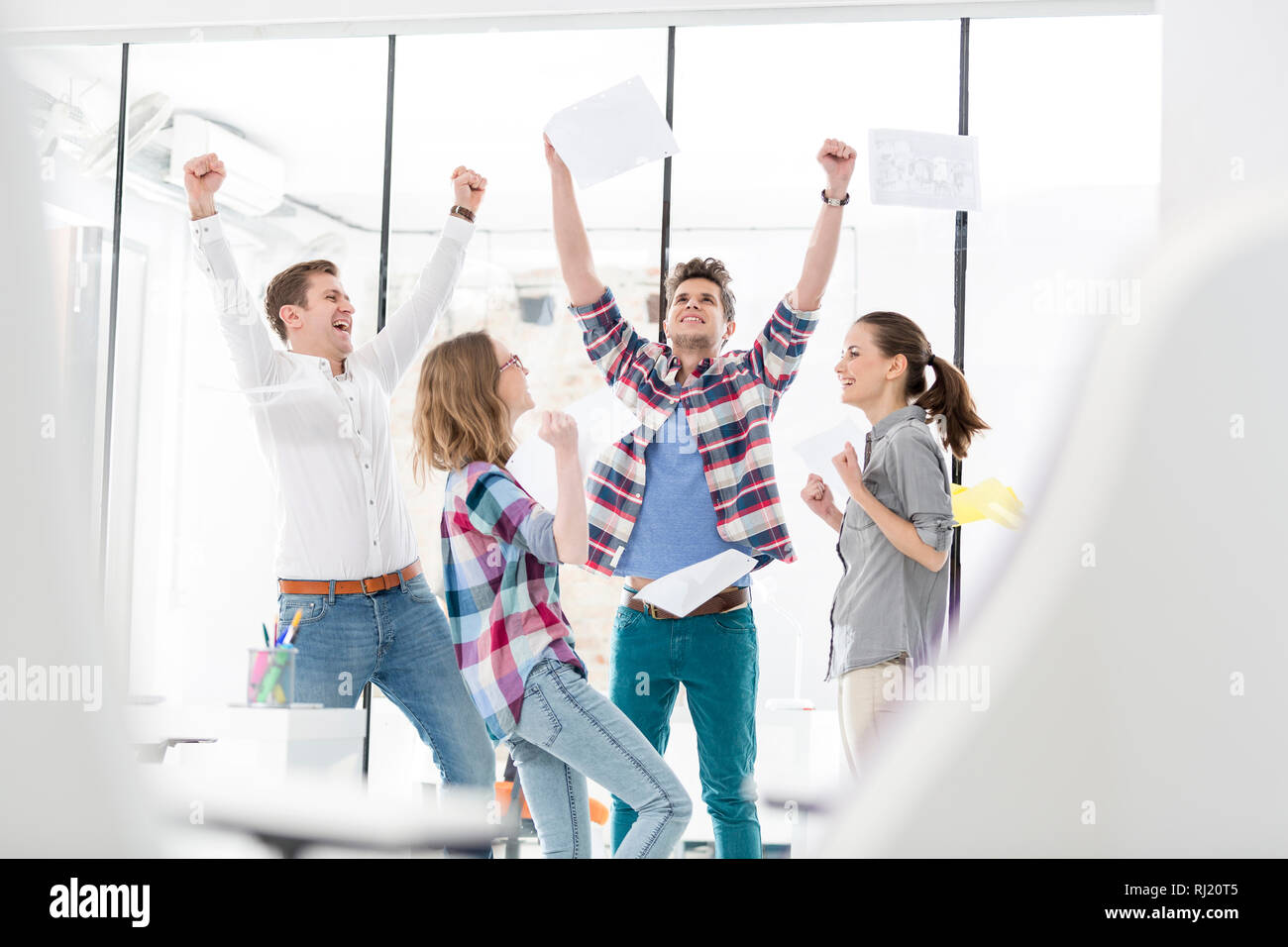 Successful business colleagues cheering in office Stock Photo - Alamy