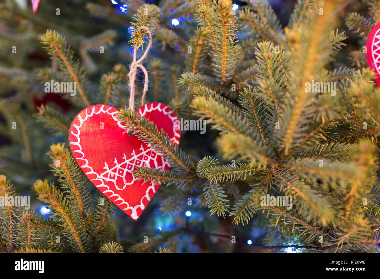 Red heart on spruce and pine background. Valentine's Day. Symbol of ...