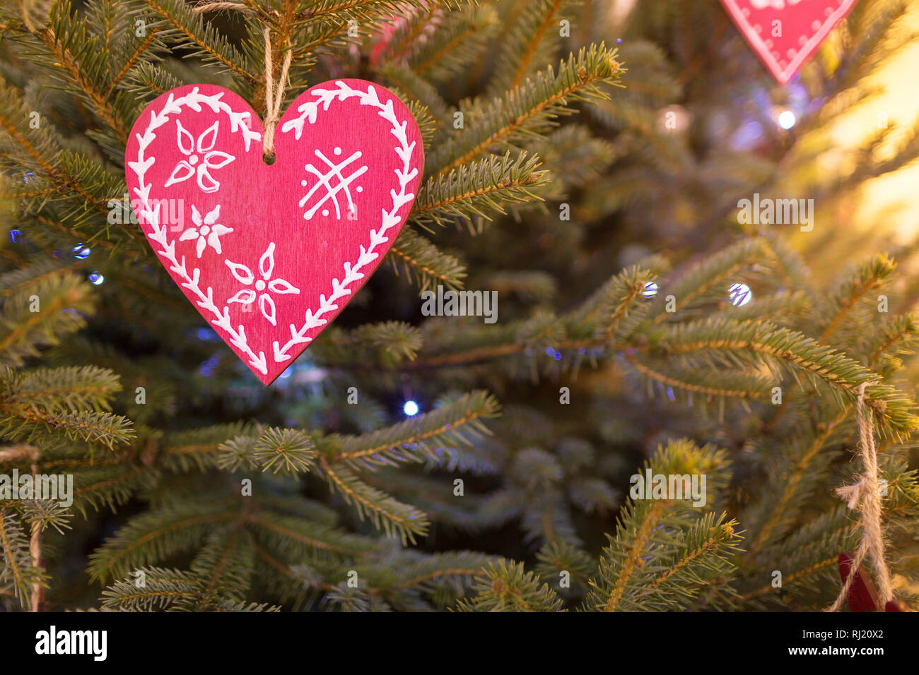 Red heart on spruce and pine background. Valentine's Day. Symbol of ...