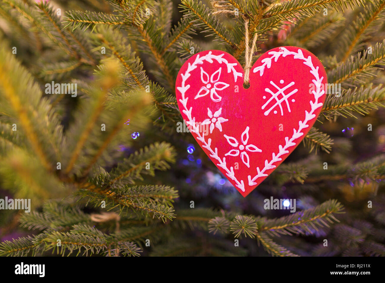 Red heart on spruce and pine background. Valentine's Day. Symbol of ...