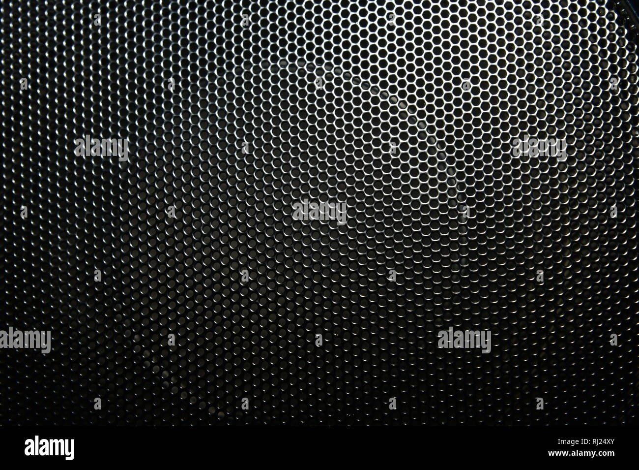 The speaker of a musical column hidden behind a grid with a pattern of ...