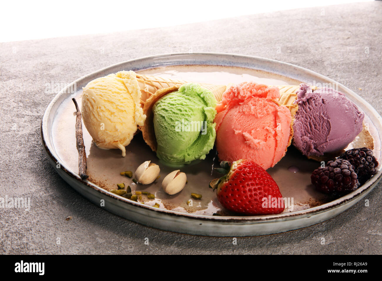 Set of ice cream scoops of different colors and flavours with berries ...