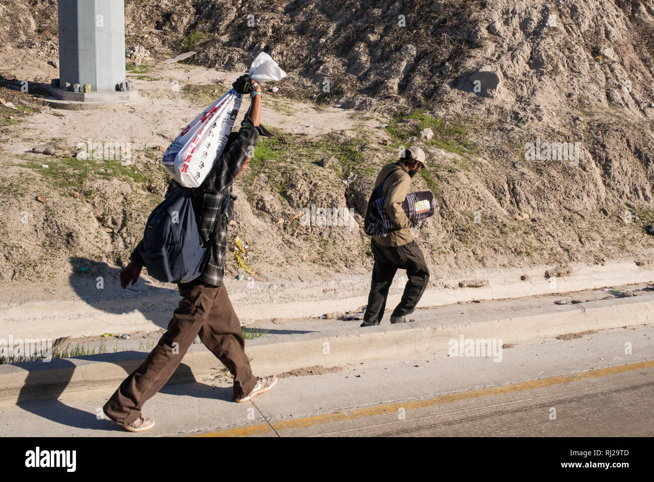 Tijuana, Mexico: Honduran refugees walk along the border with USA Stock ...