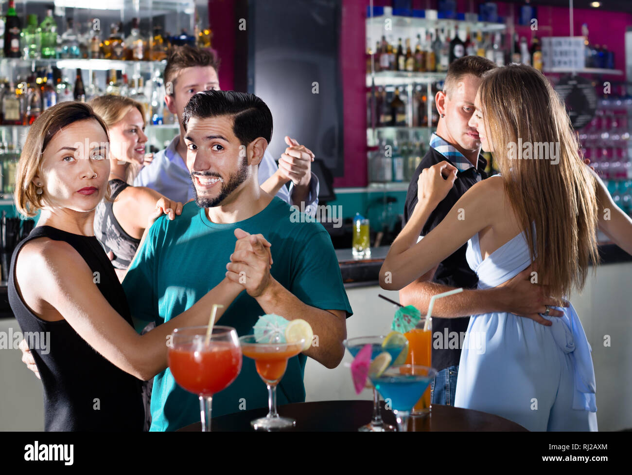 Female with man are dancing in pair on the party in bar Stock Photo - Alamy