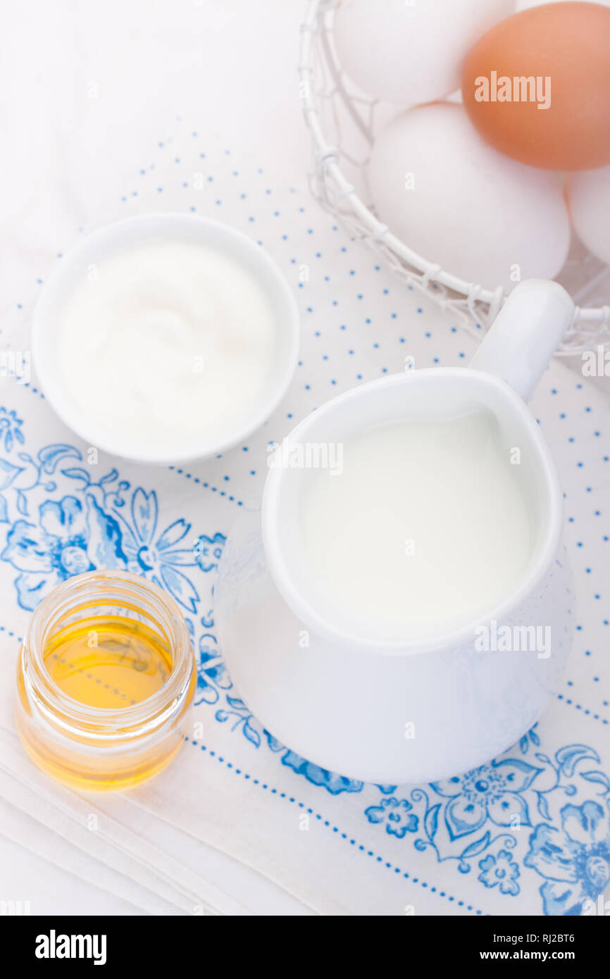 Composition with milk, yoghurt, honey and eggs Stock Photo - Alamy