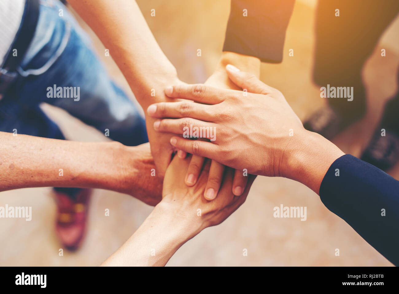 Concept of teamwork: Close-Up of hands business team showing unity with putting their hands ...