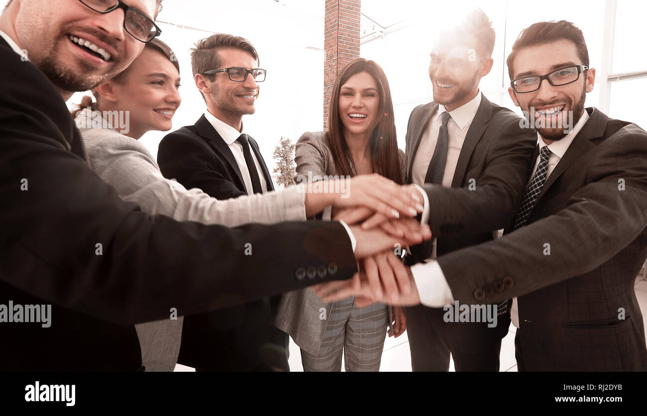 group of business people folding a tower out of their hands Stock Photo ...