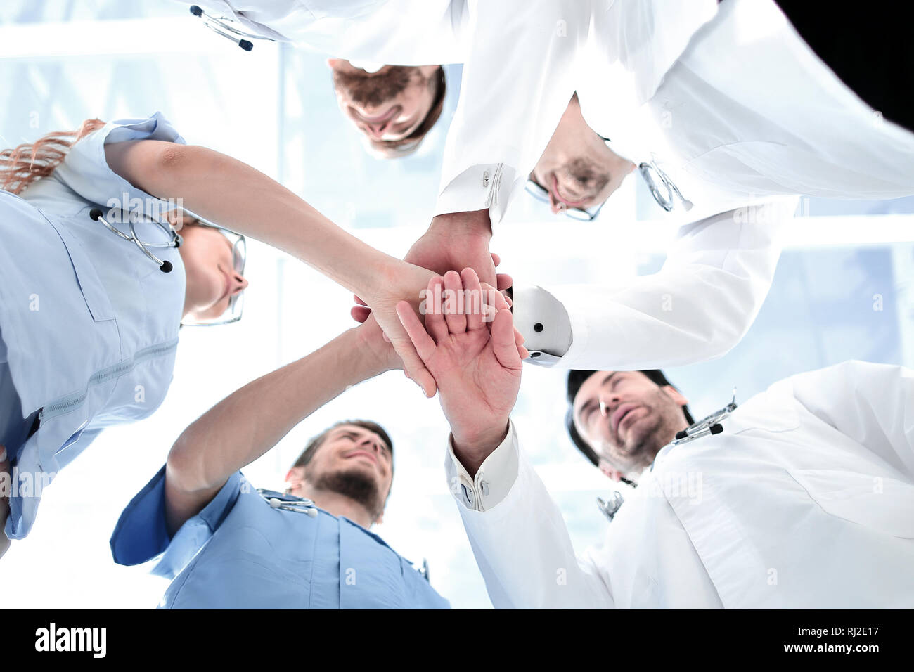 Health care workers demonstrating unity, bottom view Stock Photo - Alamy