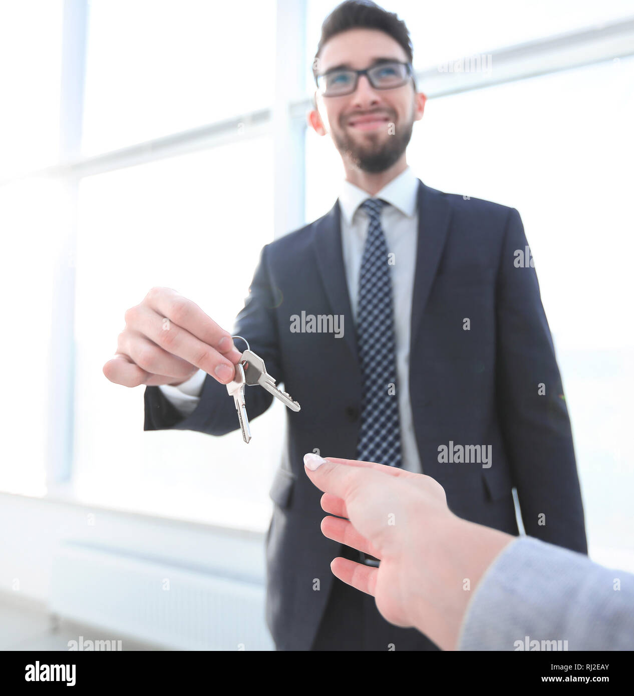 Estate Agent Giving House Keys To Person Stock Photo - Alamy