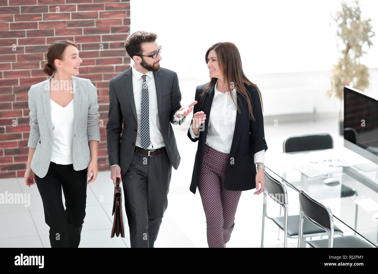 boss and employees walk around the office Stock Photo - Alamy