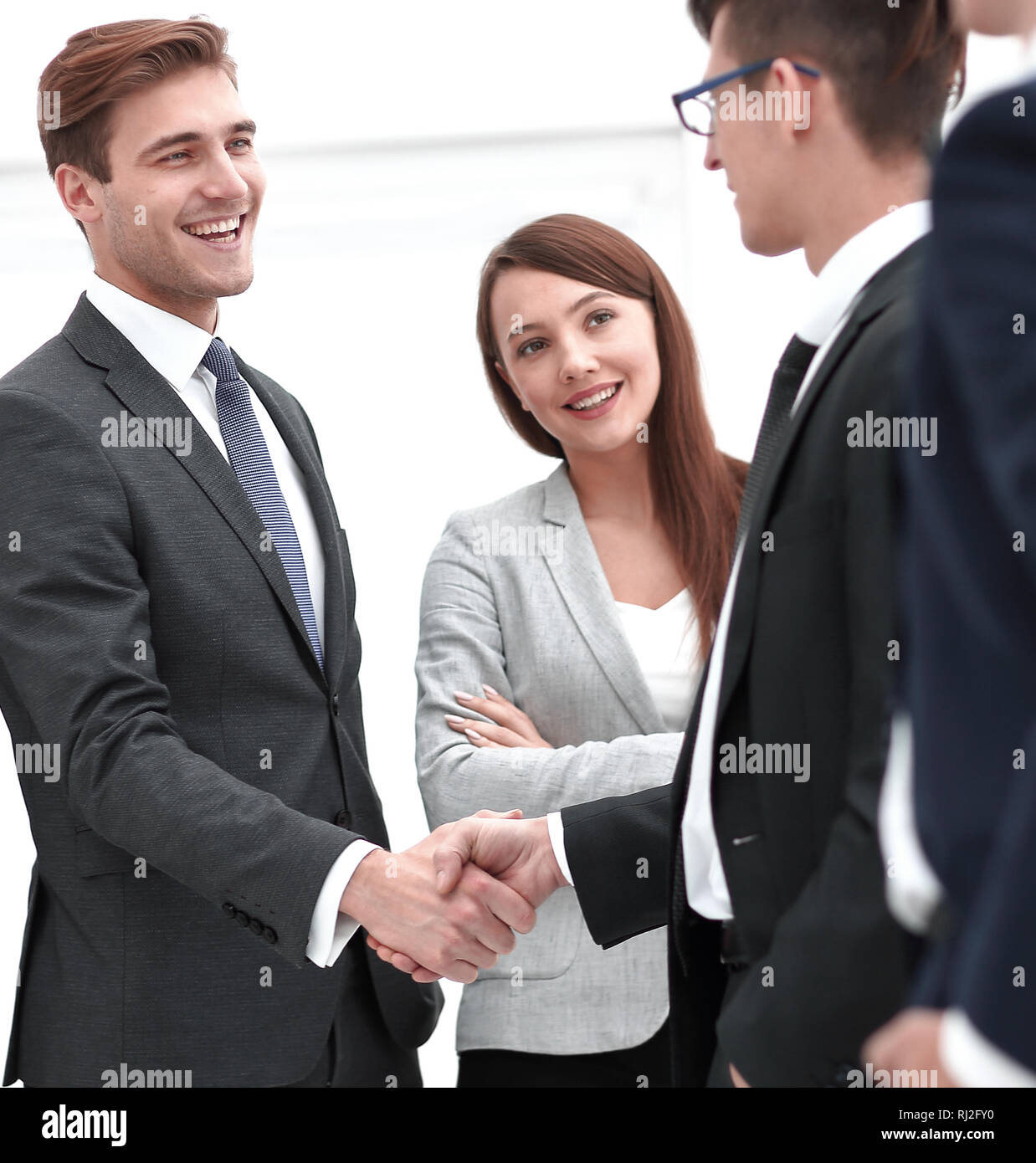 colleagues shaking hands in office Stock Photo - Alamy