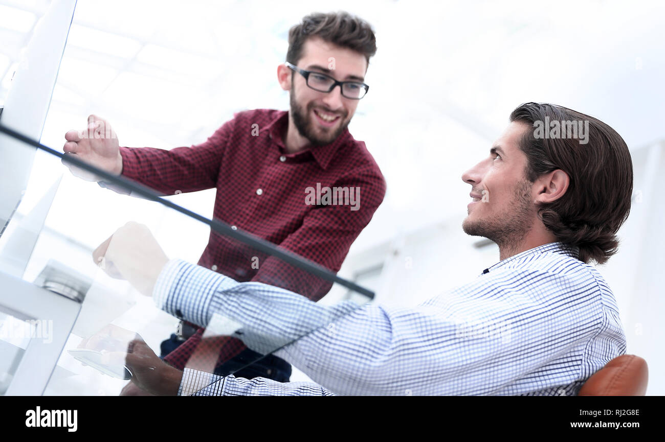 bottom view.businessman sitting behind a Desk Stock Photo - Alamy