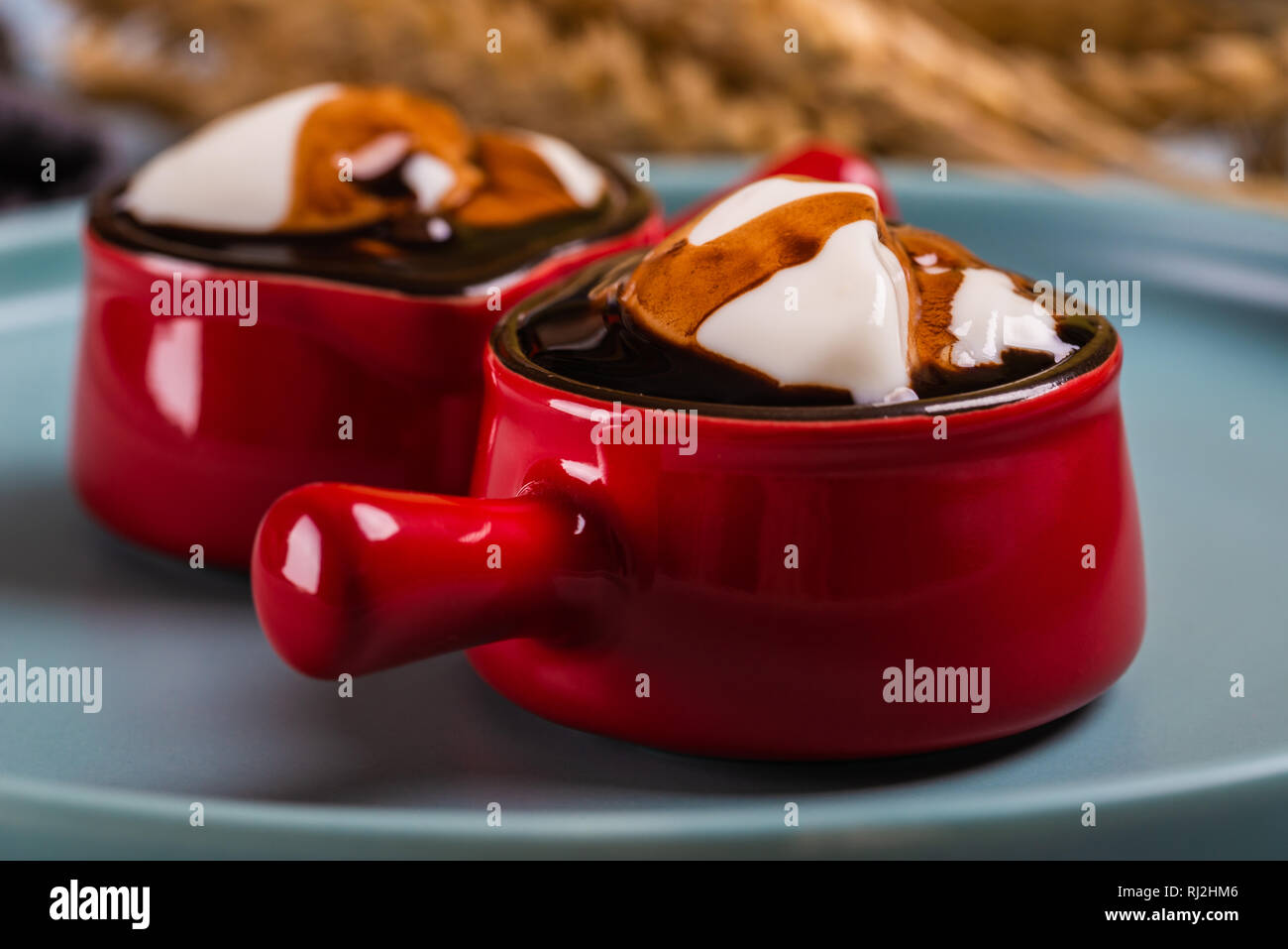 White whipped cream in two nice small red cups with handle Stock Photo ...