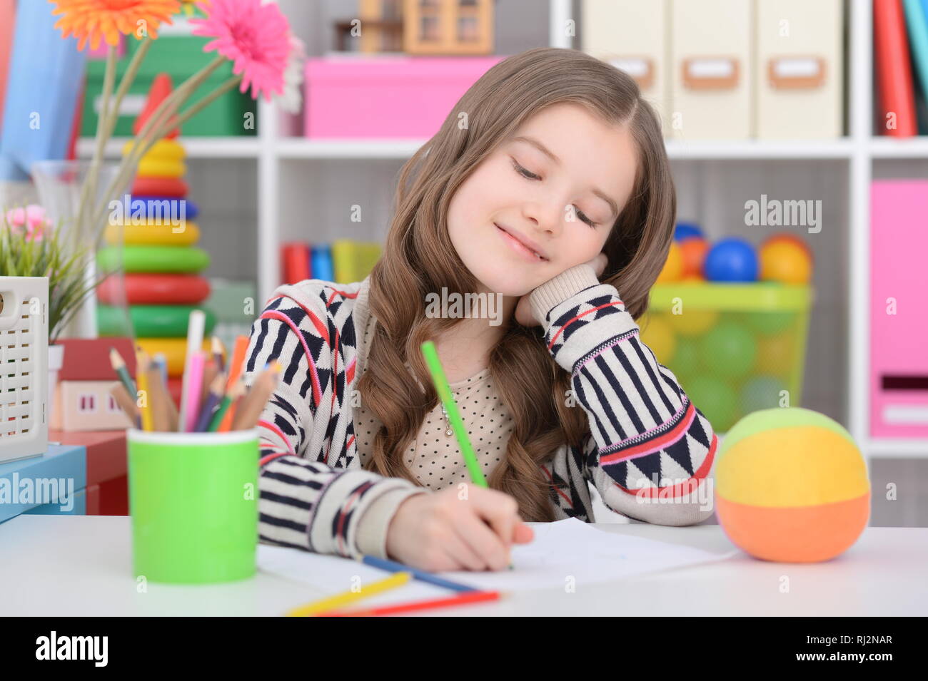 Portrait of cute little girl doing homework Stock Photo - Alamy