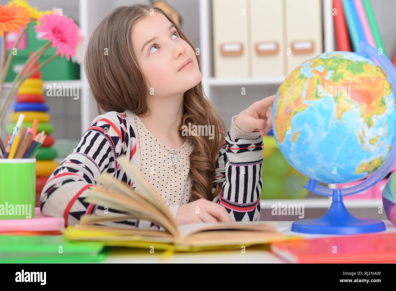 Portrait of cute little girl doing homework Stock Photo - Alamy