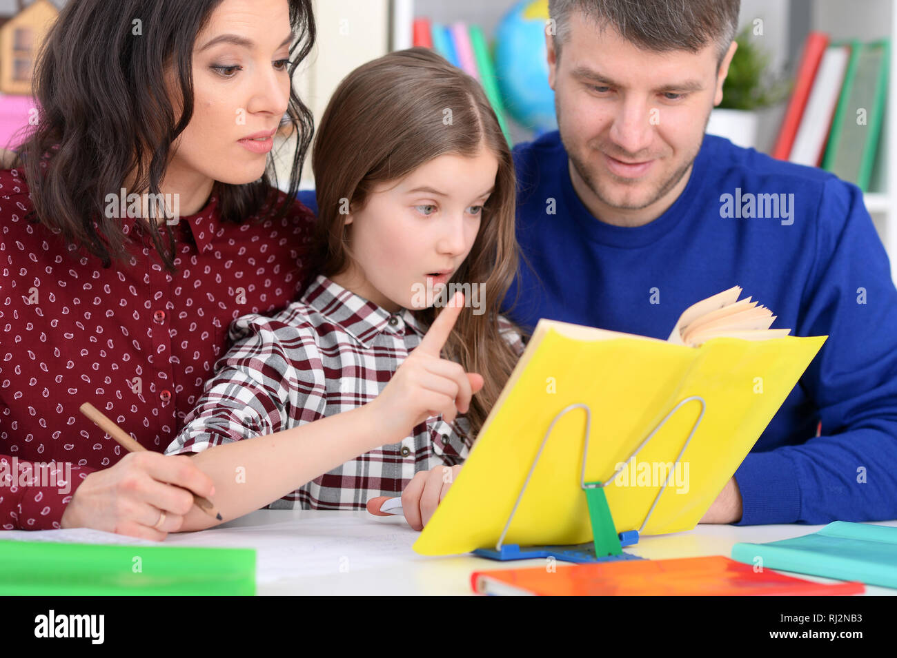 Parents doing homework with children hi-res stock photography and ...