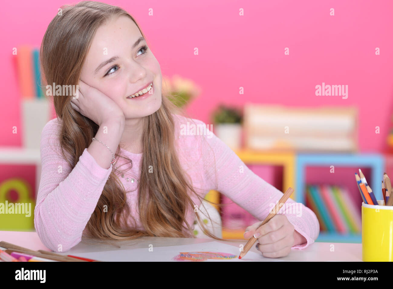 Portrait of cute happy girl drawing at home Stock Photo - Alamy