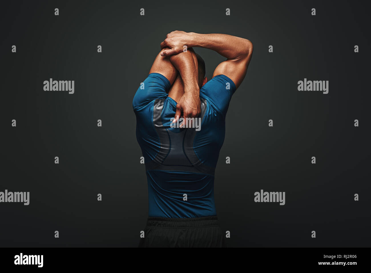 Portrait of strong young muscular man stretching his arms. Fitness ...