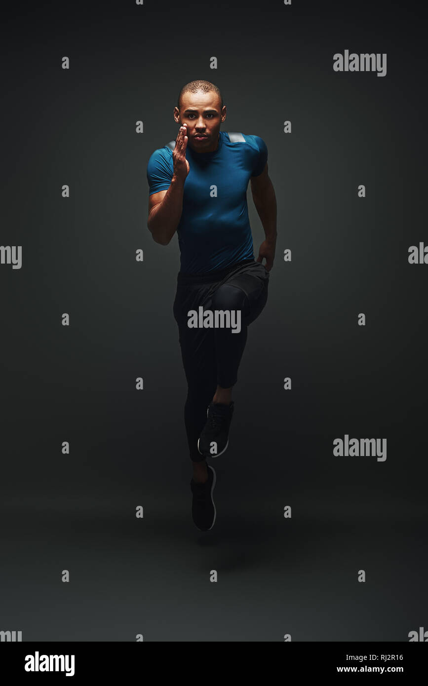 Full length portrait of a healthy muscular sportsman running isolated ...